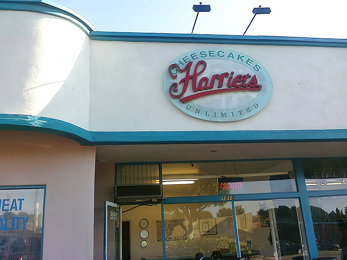 The unassuming storefront of Harriet's Cheesecakes Unlimited in Inglewood – proof that culinary greatness often hides in plain sight behind modest blue trim.