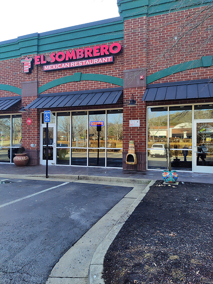The unassuming brick exterior of El Sombrero belies the culinary treasures within. Red signage and a simple "OPEN" sign invite curious diners to discover Franklin's hidden Mexican gem.