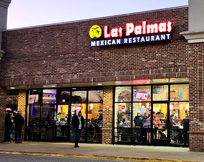 The brick façade of Las Palmas welcomes hungry visitors with its cheerful palm tree logo and bold red lettering—a modest exterior hiding culinary treasures within.