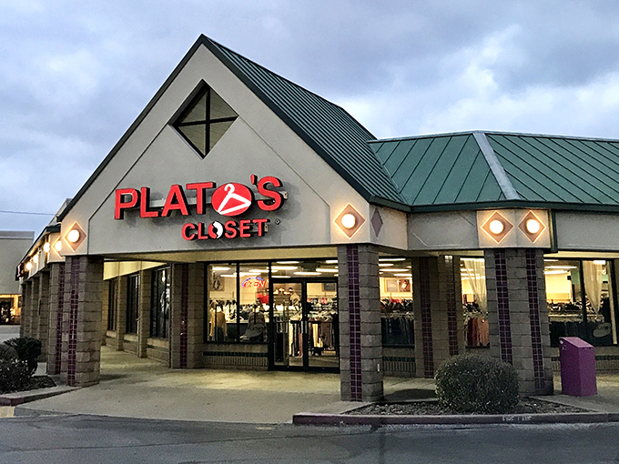 The distinctive green-roofed exterior of Plato's Closet in Fayetteville welcomes fashion hunters with the promise of treasures within.