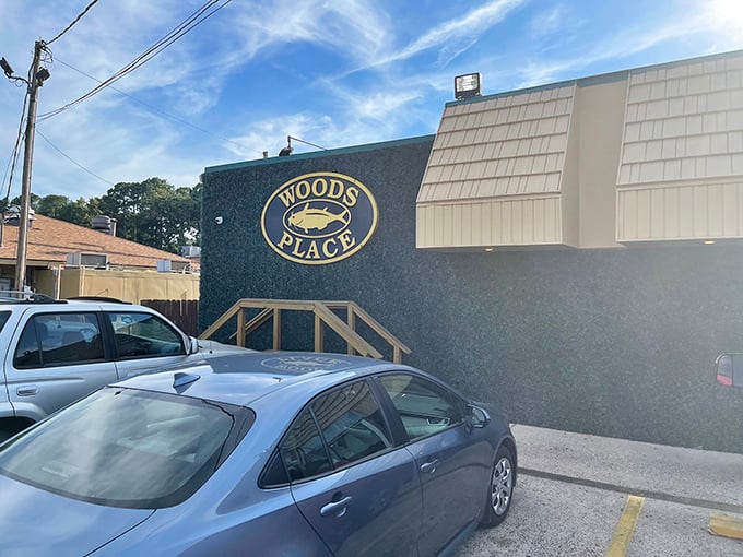 The unassuming exterior of Woods Place, with its distinctive green trim and simple sign, stands as Camden's culinary beacon for catfish aficionados.
