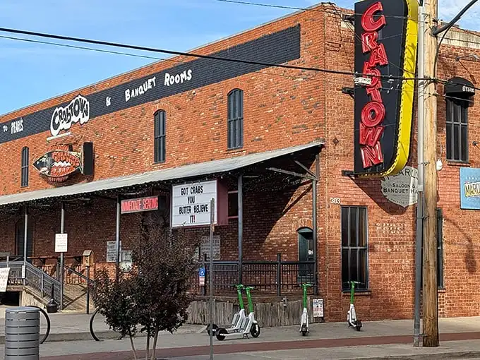 The iconic red neon "CRATOWN" sign beckons hungry travelers like a lighthouse for landlocked seafood lovers in Oklahoma City's Bricktown district.