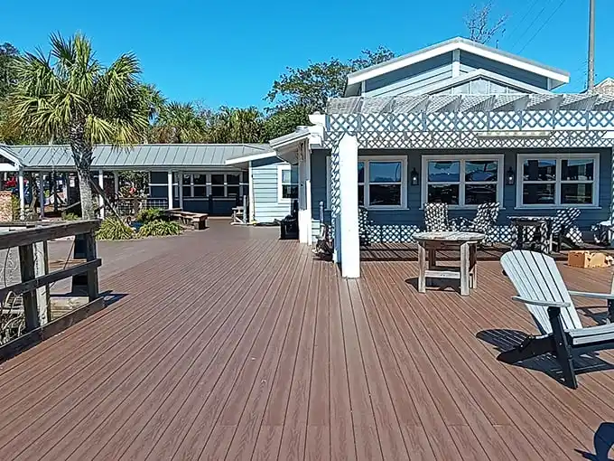 The wooden deck at Skipper's Fish Camp invites you to slow down and breathe in that coastal air. Those rocking chairs aren't just furniture—they're an invitation to linger.