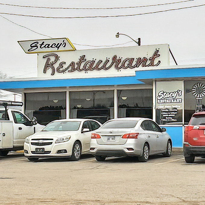 The classic neon sign beckons like an old friend. Stacy's Restaurant stands proudly against the Kansas sky, promising comfort and nostalgia with every meal.
