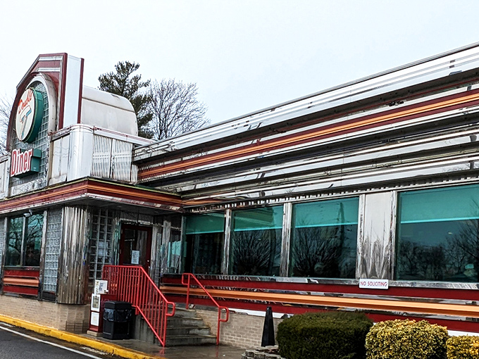 The retro facade of Double T Diner glows like a beacon for hungry travelers. Classic glass blocks and chrome trim scream "authentic American diner experience."