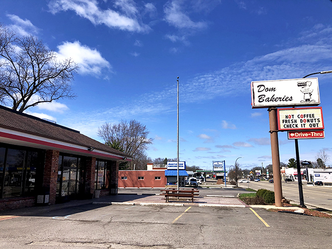 The vintage sign beckons like a lighthouse for the sugar-deprived. Dom Bakeries' retro charm stands strong against fast food uniformity. 