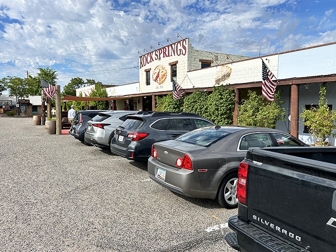 The iconic white facade of Rock Springs Café stands proudly against the Arizona sky, with that painted pie slice practically winking at hungry travelers on I-17.