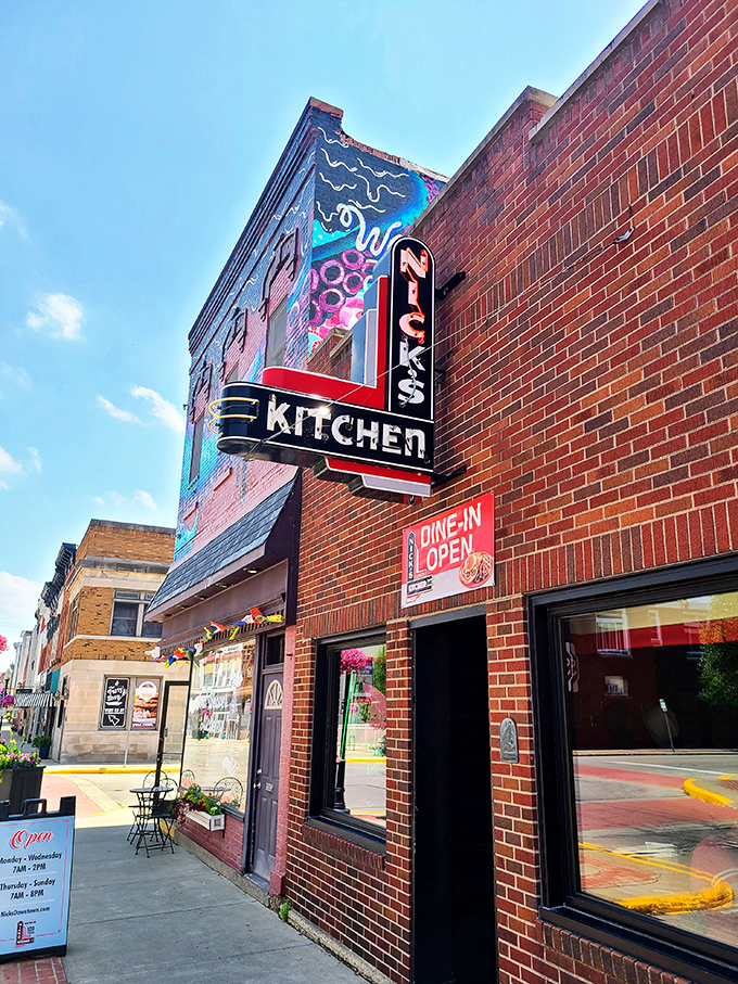 The iconic neon sign of Nick's Kitchen stands as a beacon of culinary history on Huntington's Jefferson Street. A century of tenderloin tradition lives behind this brick façade.