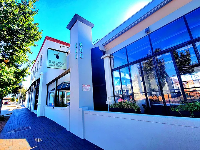 The wooden slat exterior of The Grove isn't just stylish—it's a preview of the warmth waiting inside, like a delicious secret the building can barely contain.
