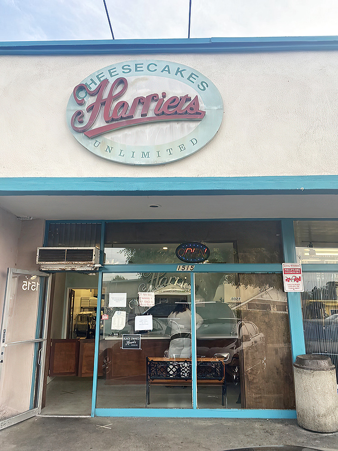 The unassuming storefront of Harriet's Cheesecakes Unlimited in Inglewood – proof that culinary greatness often hides in plain sight behind modest blue trim.