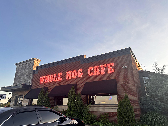 The barbecue beacon of North Little Rock stands proud with its red roof and pig silhouettes, boldly declaring its championship status to hungry passersby.