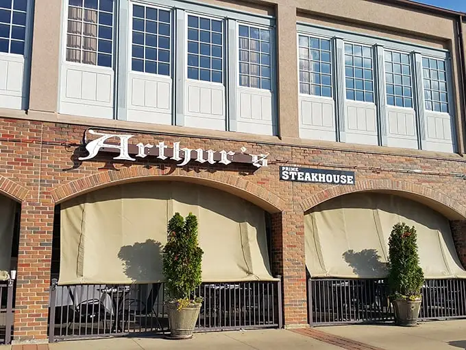 The modern façade of Arthur's Prime Steakhouse belies the old-world charm within. String lights create an inviting glow as evening approaches.