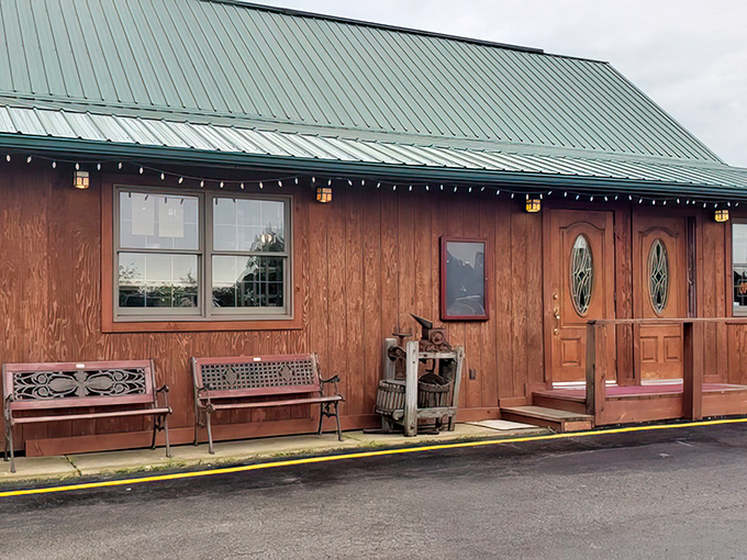 The red-stained timber exterior of Rustic Oak beckons like a carnivore's lighthouse in rural Missouri—rustic benches inviting you to sit a spell before the feast begins.