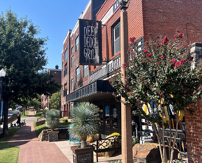 The brick-lined entrance to Deep Deuce Grill beckons like an old friend, promising good times and even better food in this historic Oklahoma City district.