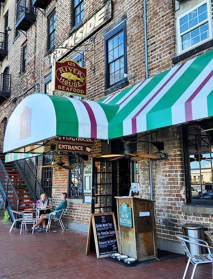The iconic green and white striped awnings of River House welcome you to a slice of Savannah history on the cobblestone riverfront.
