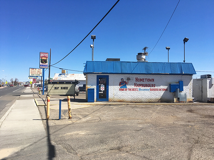 The blue-roofed burger sanctuary beckons with its no-nonsense promise: "Home of the best, seasoned burgers in town." No argument here.