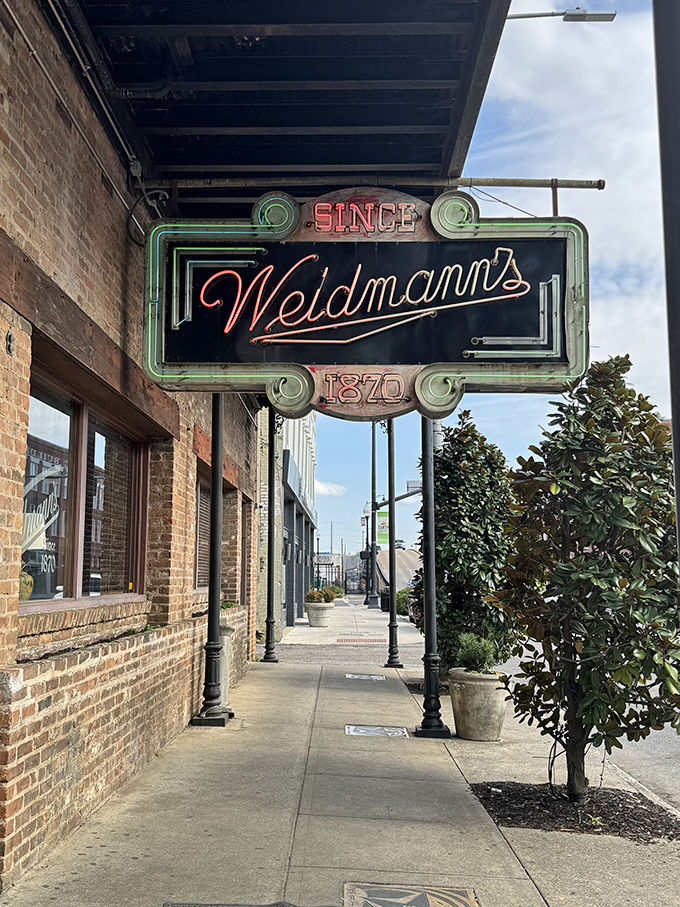 The iconic neon sign of Weidmann's glows like a beacon of culinary hope on a downtown Meridian street. Southern hospitality awaits just beyond those doors.