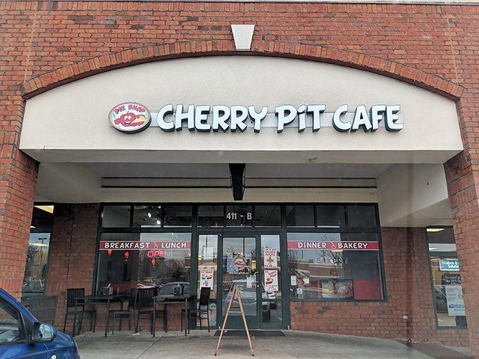 The bright signage of Cherry Pit Cafe promises comfort before you even walk through the door. Like finding a $20 bill in an old jacket pocket—unexpectedly delightful.
