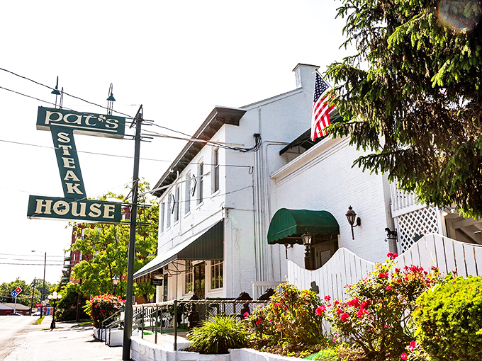 The unassuming green exterior of Pat's Steakhouse hides culinary greatness like a superhero's secret identity. That modest sign has guided hungry Louisvillians for generations.