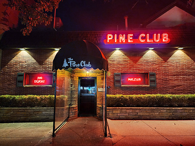 The iconic green awning and brick facade of The Pine Club stands as Dayton's temple to timeless steakhouse tradition.