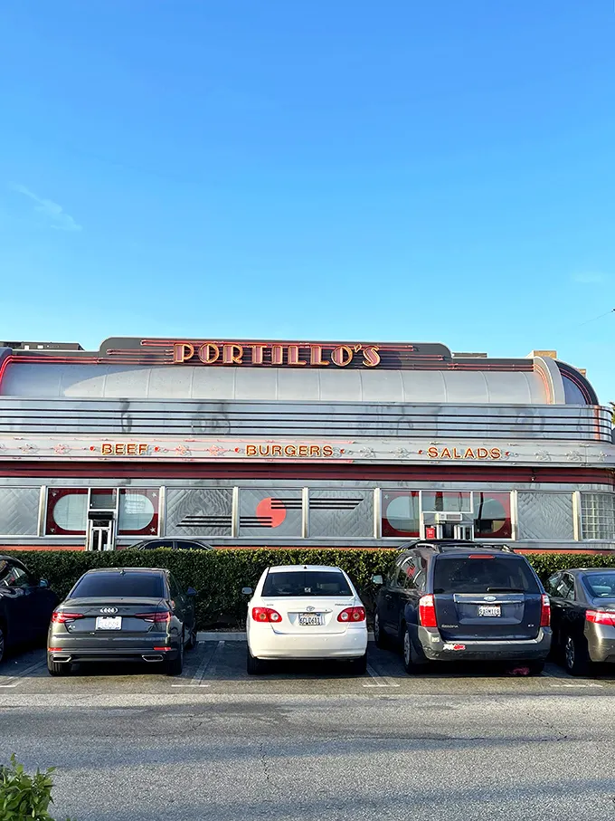 The neon-drenched exterior of Portillo's glows like a beacon of Midwestern comfort food in the Southern California night. Chicago never looked so good in California.