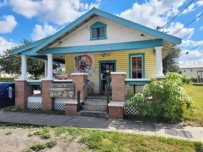 The yellow bungalow with turquoise trim stands like a barbecue beacon in Tampa, promising smoky treasures within its humble walls.