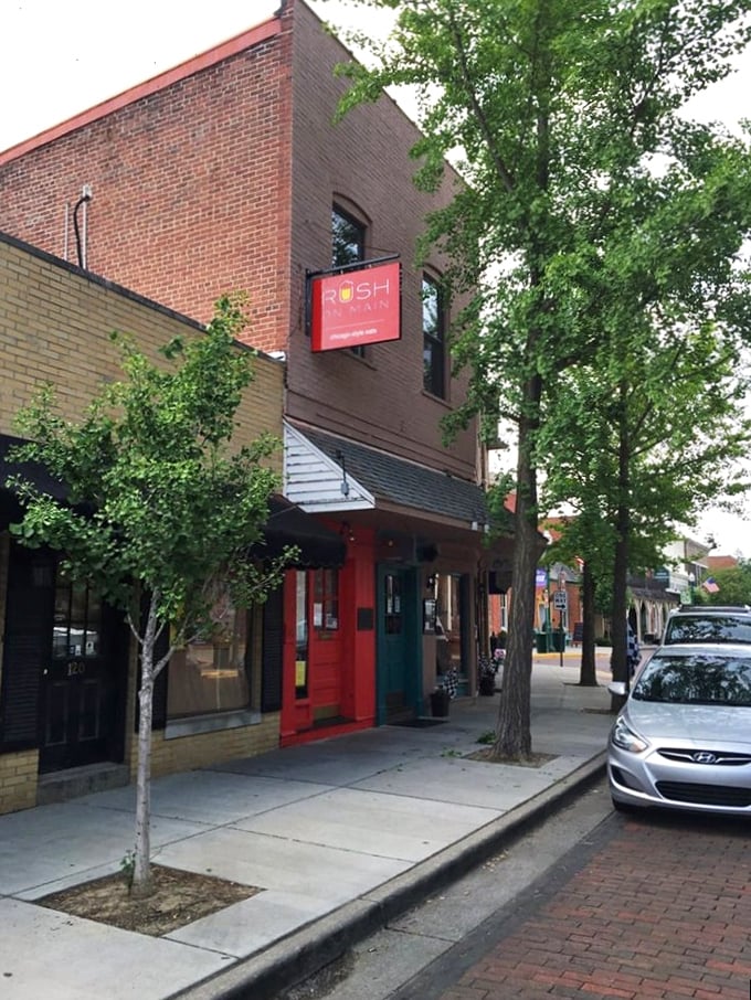 The bright red door at Rush on Main stands out like a beacon on Zionsville's Main Street, promising Chicago-style delights within these historic walls.