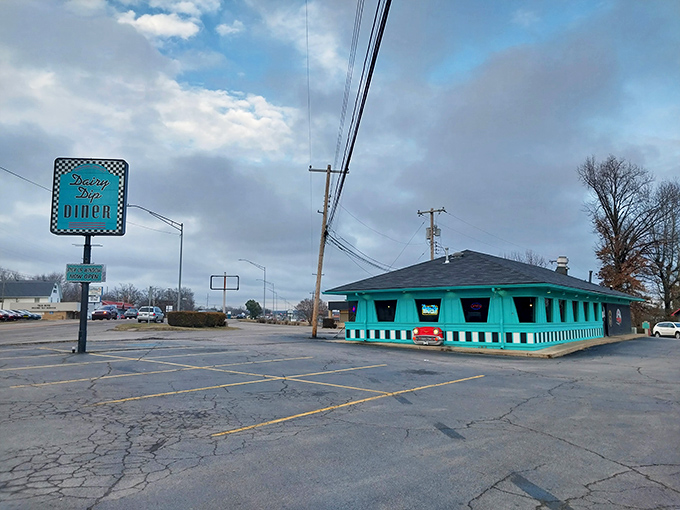 That unmistakable turquoise exterior isn't just a building—it's a time portal disguised as a diner. The Dairy Dip's vintage sign practically winks at passersby.