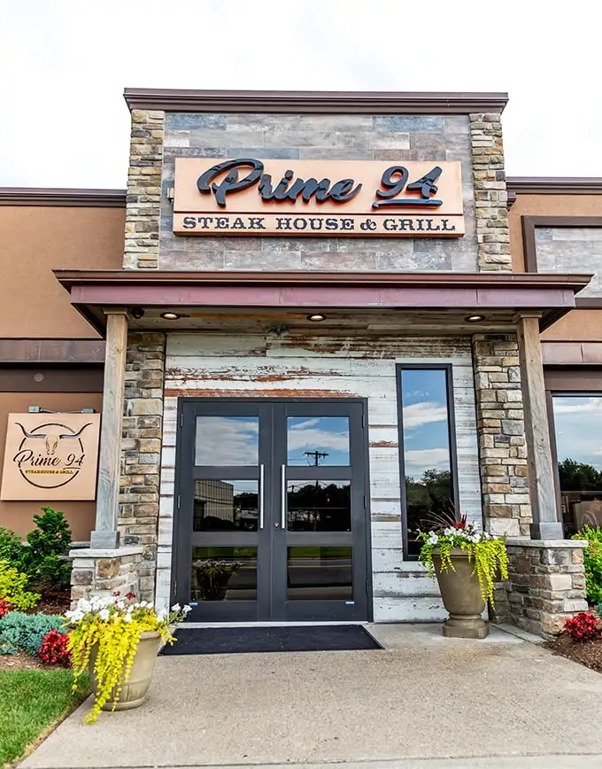 Stone facade, lush landscaping, and an American flag – Prime 94 announces itself with the confidence of a restaurant that knows exactly what it's doing.