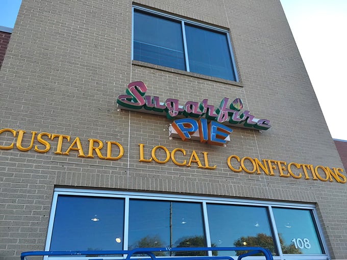 The colorful Sugarfire Pie sign promises "Custard Local Confections" – a beacon of sweetness in Olivette that delivers on every sugary syllable.
