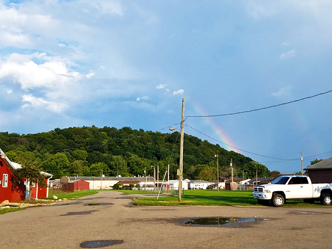 A rainbow graces the hills of Logan, nature's way of saying "stick around, the show's just getting started."