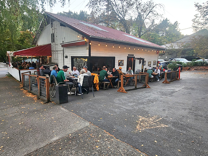 The charming white exterior of Goose Hollow Inn, where weeping willows create nature's perfect canopy for Portland's beloved sandwich sanctuary.