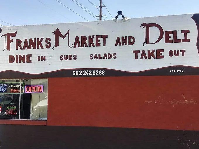 The bright red exterior of Frank's Market and Deli stands like a culinary lighthouse in Phoenix, beckoning sandwich enthusiasts from miles around.