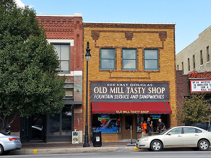 The Old Mill Tasty Shop's brick façade stands proudly on Douglas Avenue, a time capsule of Americana that's been satisfying Wichita's comfort food cravings for generations.