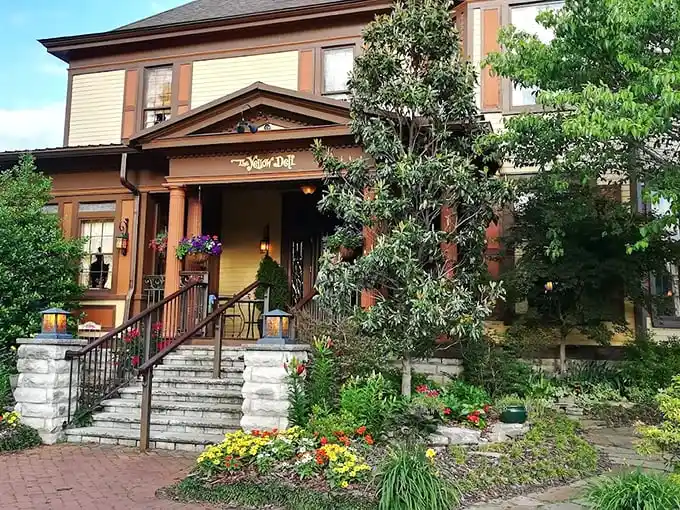 The Yellow Deli's historic façade welcomes you with stunning stone steps and vibrant gardens—like a Tennessee postcard come to life.