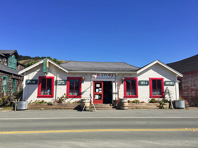 The white clapboard exterior of Elk Store stands like a culinary lighthouse on the Mendocino coast, complete with rustic wine barrels that practically whisper "good things inside."