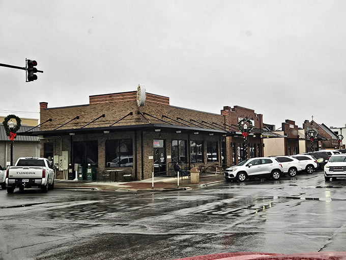 The humble brick exterior of Busy Bee Café stands like a beacon of breakfast hope, its cheerful yellow sign promising delicious revelations within.