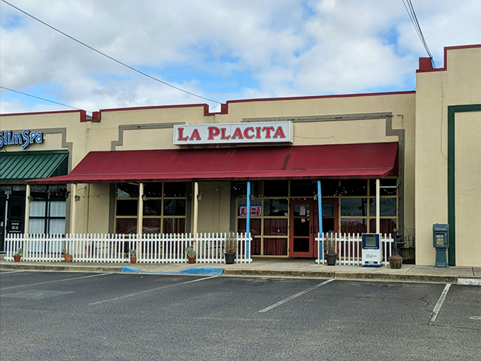 La Placita's cheerful exterior beckons with its bright yellow walls and red awning—like a sunset wrapped around a building that promises culinary adventure inside.