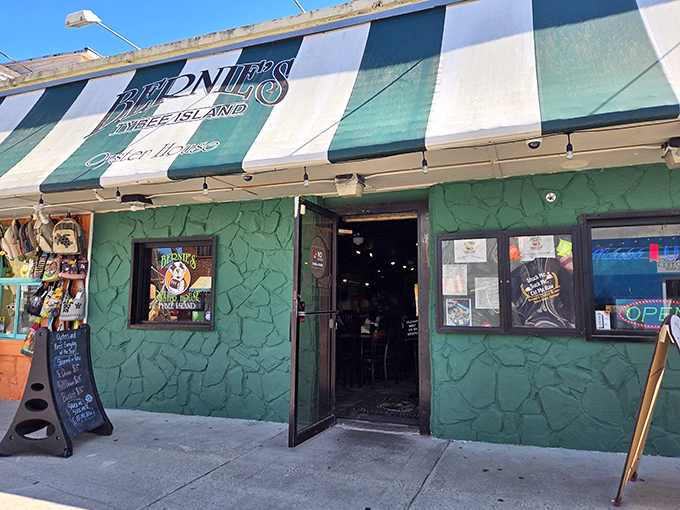 The unmistakable green façade of Bernie's with its jaunty striped awning—like a seafood speakeasy hiding in plain sight on Tybee Island.