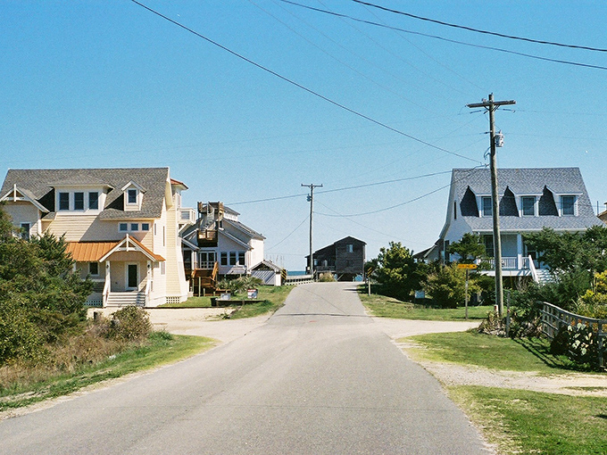 Ocracoke's main street at dusk feels like stepping into a storybook – where every shop has a tale and string lights guide your way home.