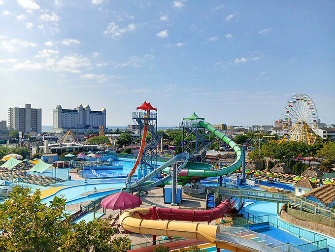 A rainbow of water slides cascades into crystal blue pools, promising the kind of summer day that makes winter worth enduring.