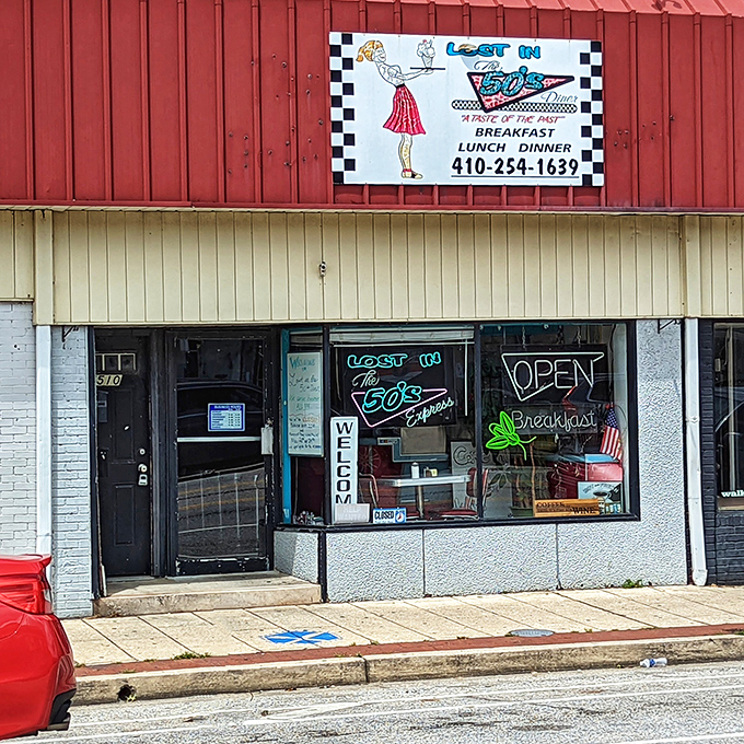 The retro storefront beckons with its cartoon waitress and checkered border—a time portal disguised as a diner on Harford Road.