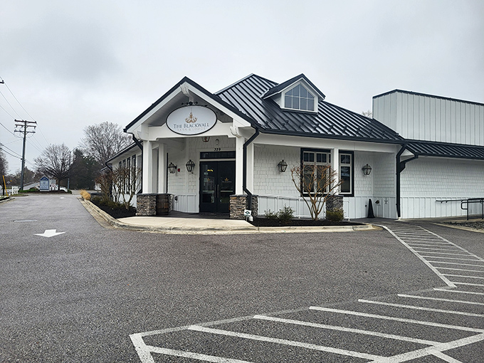 The white farmhouse exterior promises culinary magic within, like finding a surprise gift wrapped in architectural charm.