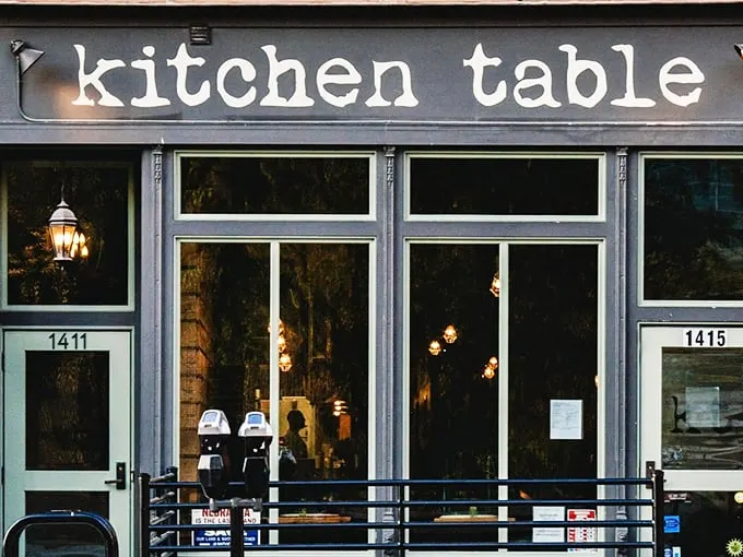 The unassuming storefront belies the culinary treasures within. Like finding a secret jazz club, Kitchen Table's exterior promises those in-the-know something special awaits.