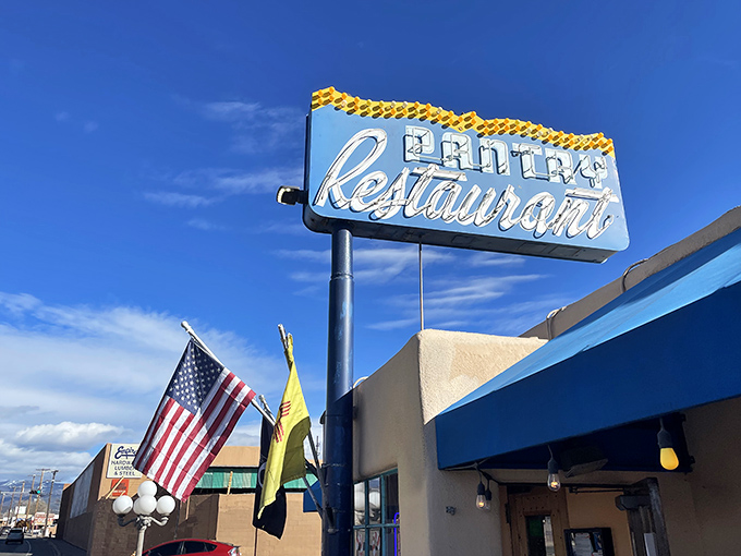 That iconic blue awning against adobe walls isn't just a sign—it's a beacon of breakfast hope for hungry Santa Feans who know the early bird gets the huevos.