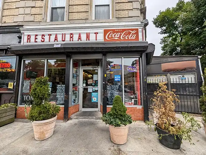 That iconic Coca-Cola sign and vintage storefront—Tom's Restaurant stands like a time capsule of old Brooklyn, promising breakfast bliss behind those doors.