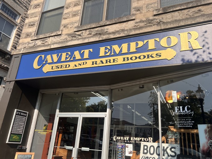 The royal blue storefront of Caveat Emptor beckons like a literary siren song. Latin for "buyer beware," but the only danger here is losing track of time.