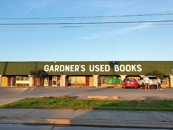 The green-sided literary fortress beckons from the roadside, promising adventures bound between covers rather than pixels.