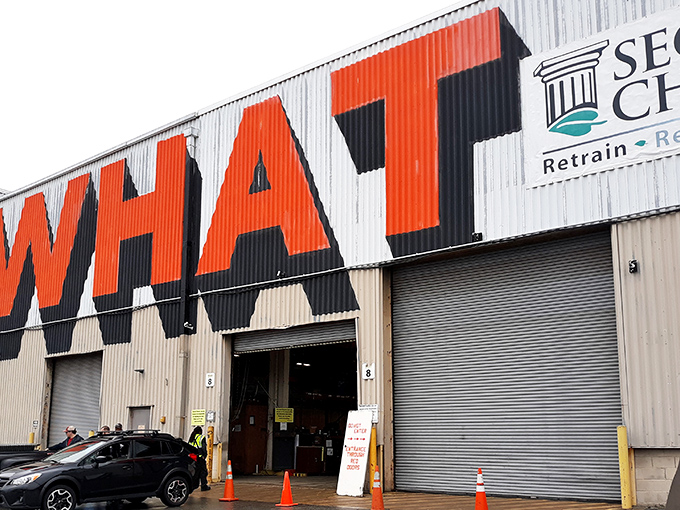 The giant "WHAT" emblazoned across this industrial facade isn't a question—it's the beginning of the treasure hunt that awaits inside Second Chance's massive warehouse.