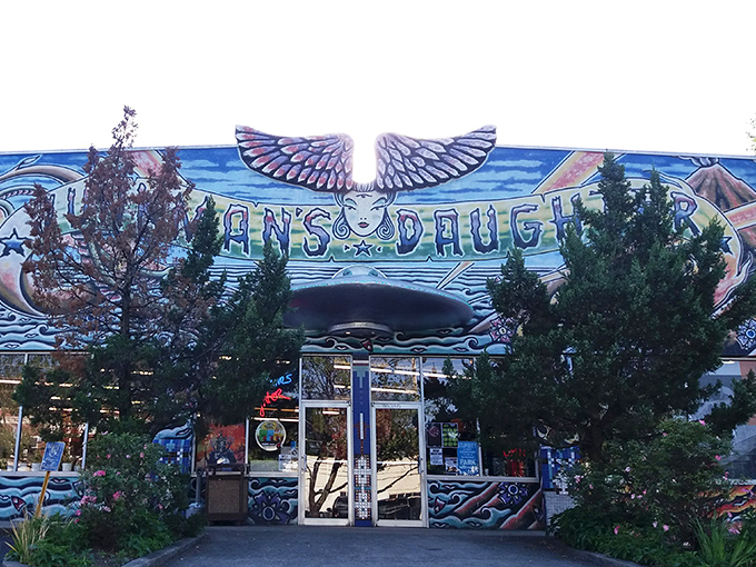 The psychedelic facade of Junkman's Daughter looks like what would happen if Salvador Dalí designed a retail store. Wings, hands, and cosmic imagery announce: normal stuff definitely not sold here.
